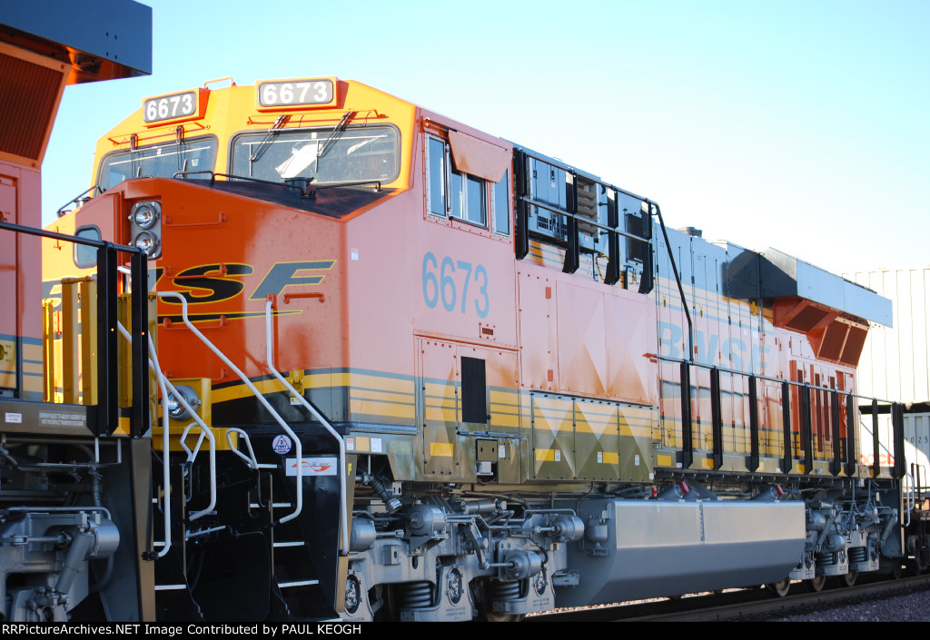 The Setting Sun's Rays Glisten of BNSF 6673 as the lead rear DPU behind the leaders BNSF 6671 ...